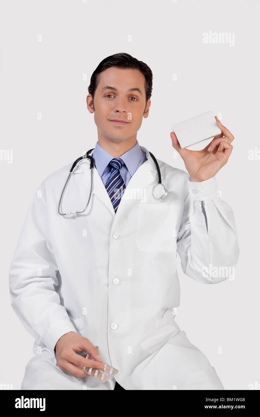 Portrait of a doctor holding a medicine pack Stock Photo - Alamy