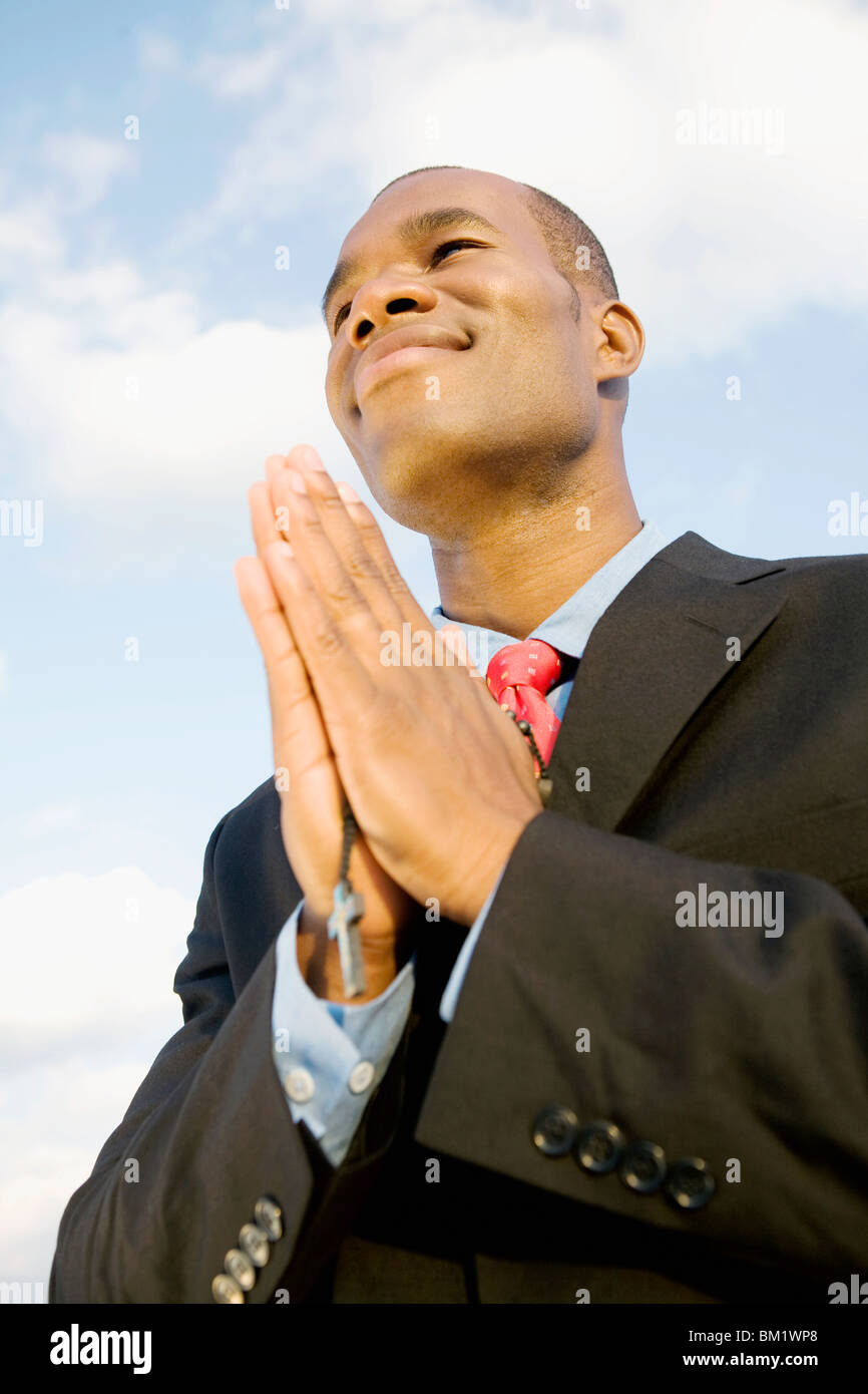 Man in suit praying looking hi-res stock photography and images - Alamy