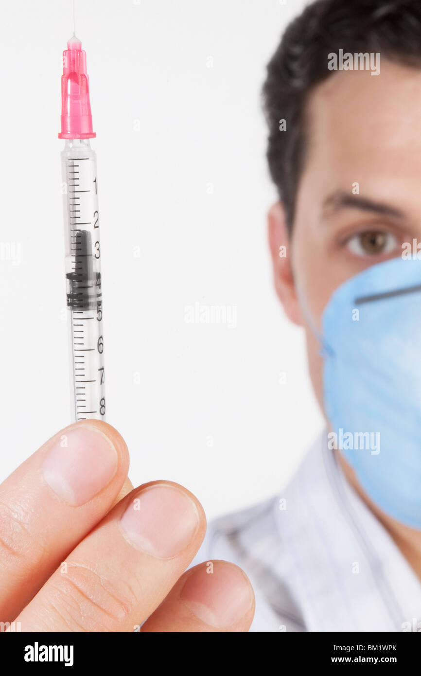 Portrait of a man showing a syringe Stock Photo - Alamy