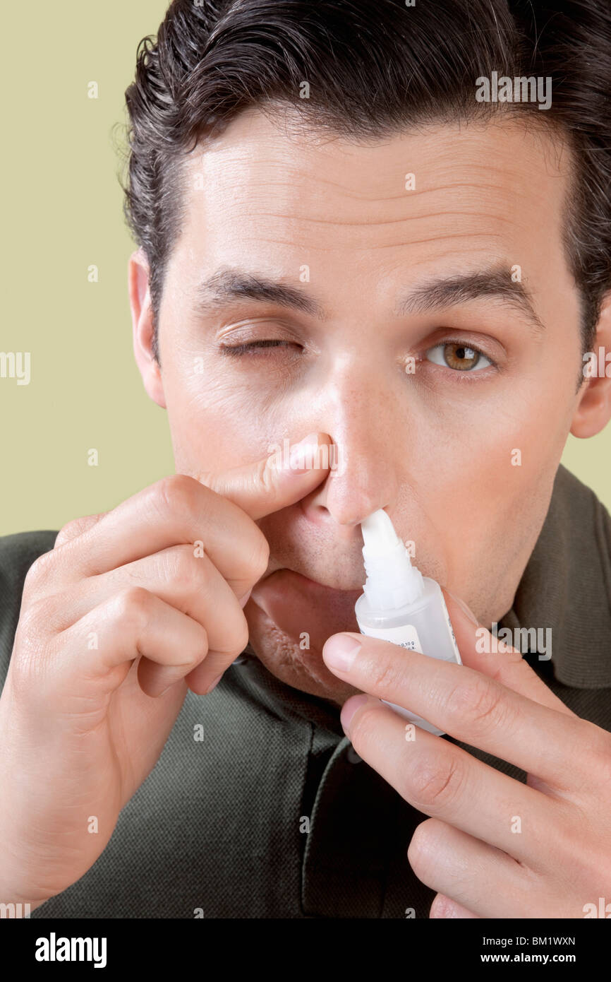 Man using nasal spray Stock Photo - Alamy
