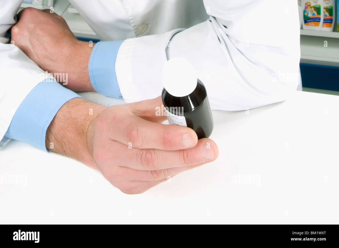 Close-up of a pharmacist's hand holding a vial of medicine Stock Photo ...