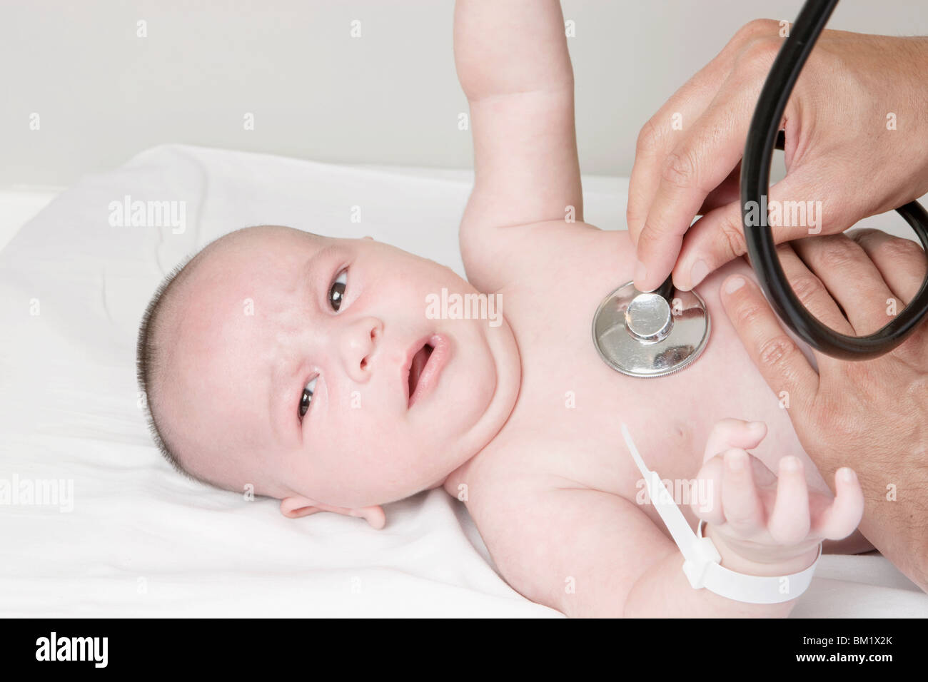Doctor examining a newborn baby Stock Photo - Alamy