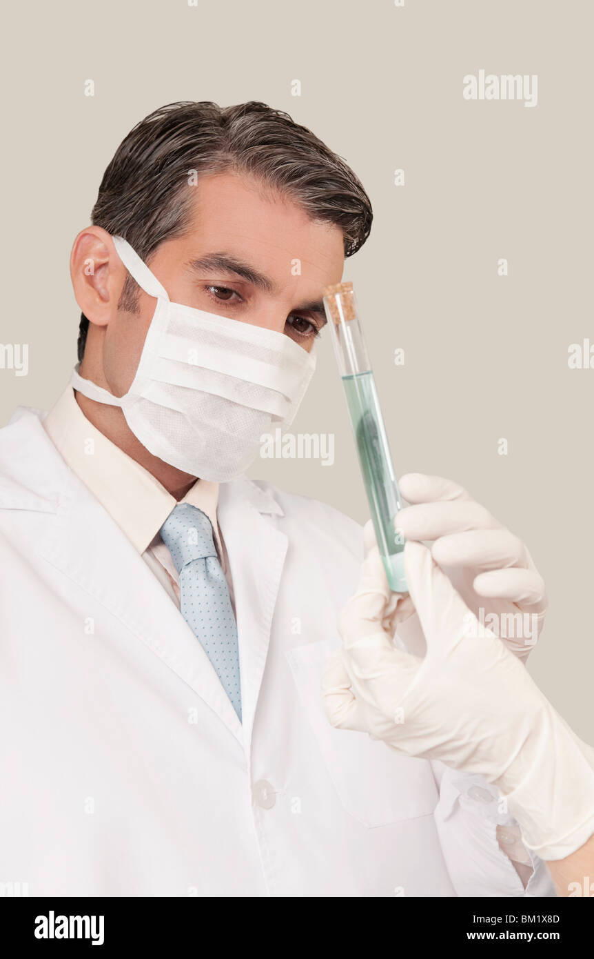 Lab technician analyzing sample in a test tube Stock Photo - Alamy