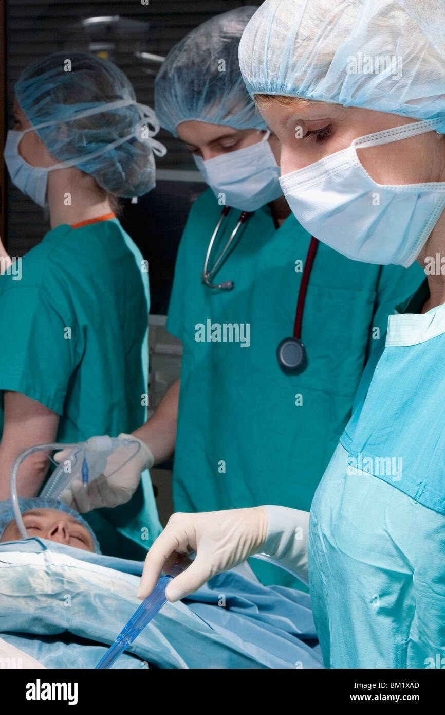 Surgeons performing a surgery in an operating room Stock Photo - Alamy