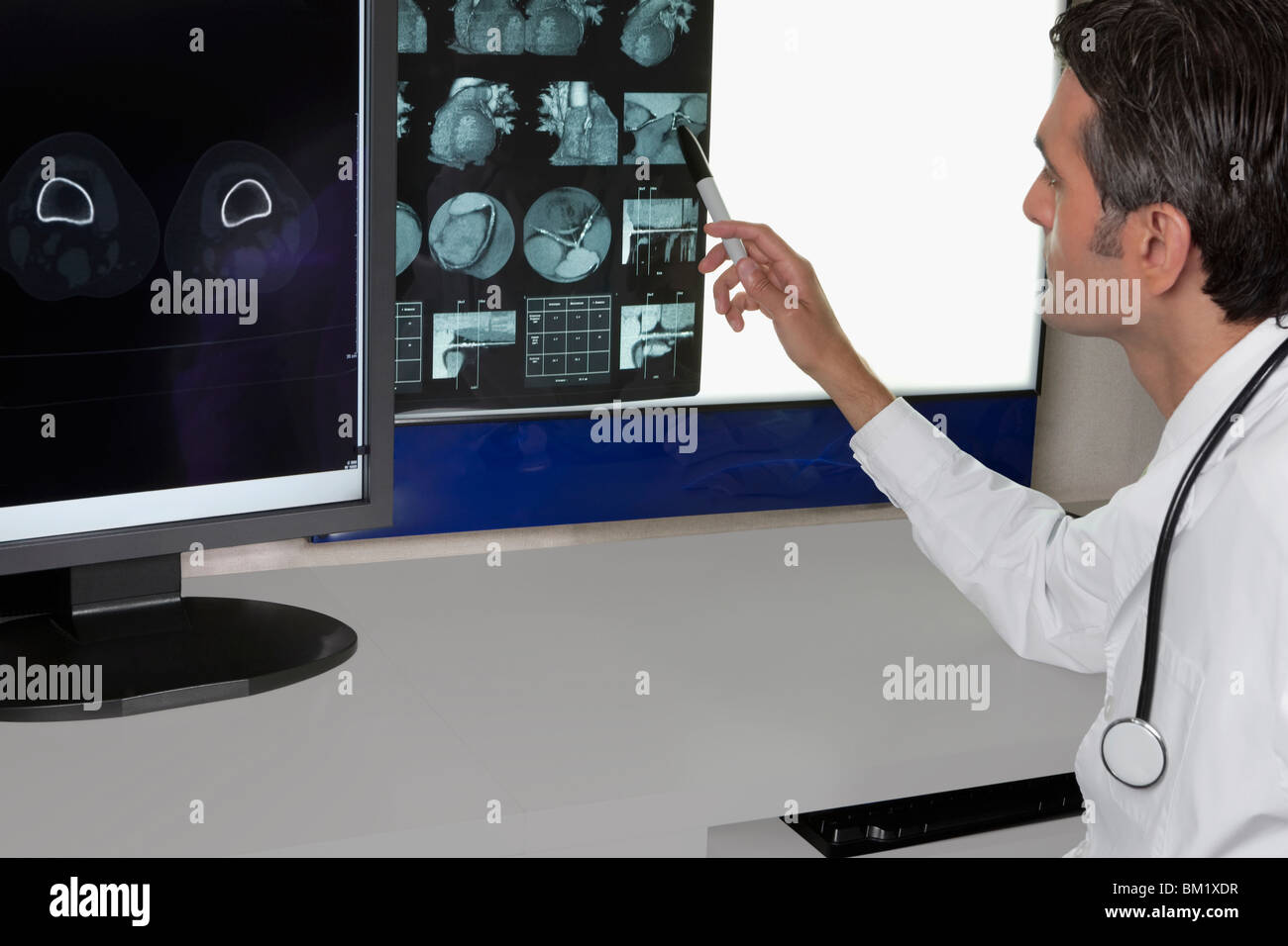 Doctor examining MRI report Stock Photo - Alamy