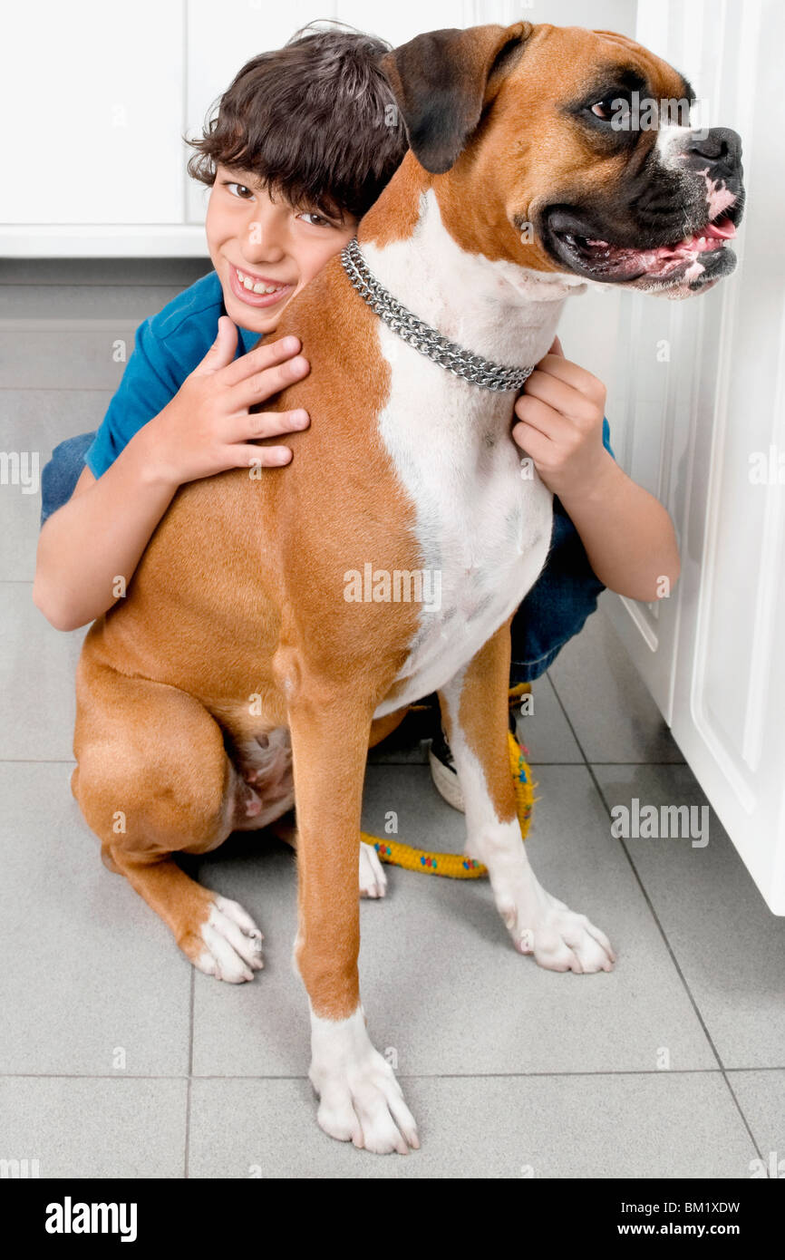 Boy hugging a dog Stock Photo - Alamy