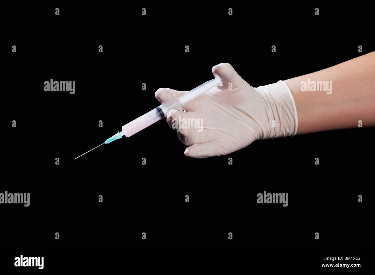 Doctor's hand holding an injection Stock Photo - Alamy