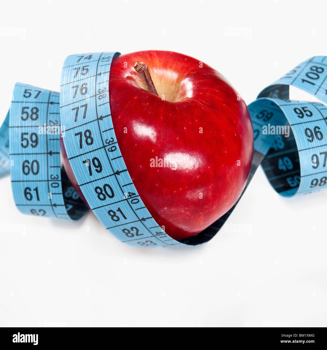 Apple wrapped in a tape measure Stock Photo - Alamy