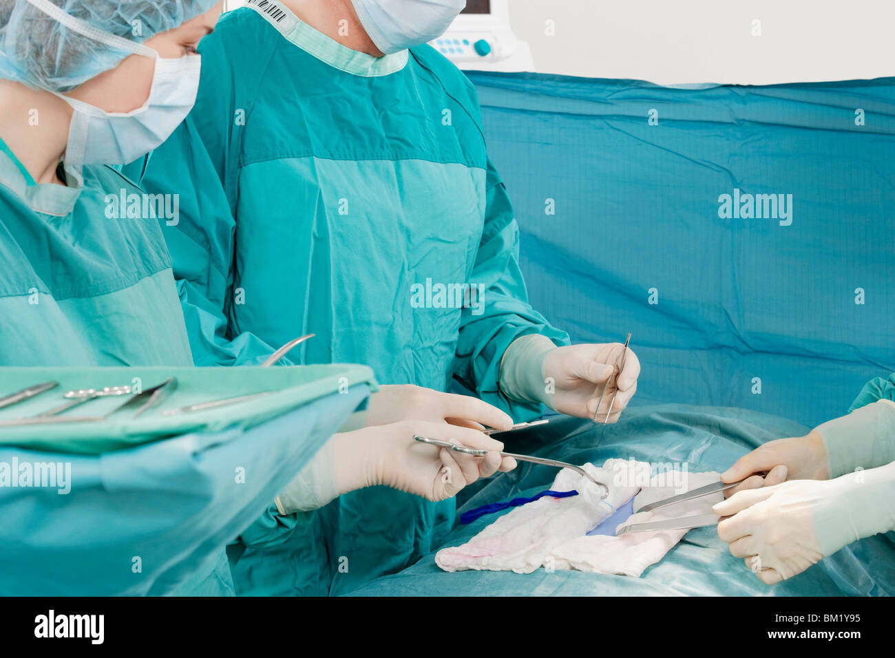 Surgeons performing a surgery in an operating room Stock Photo - Alamy