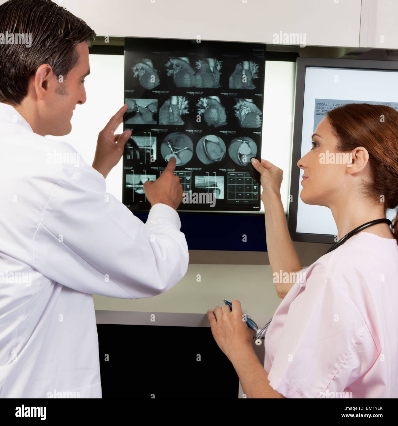 Two doctors examining MRI report Stock Photo - Alamy