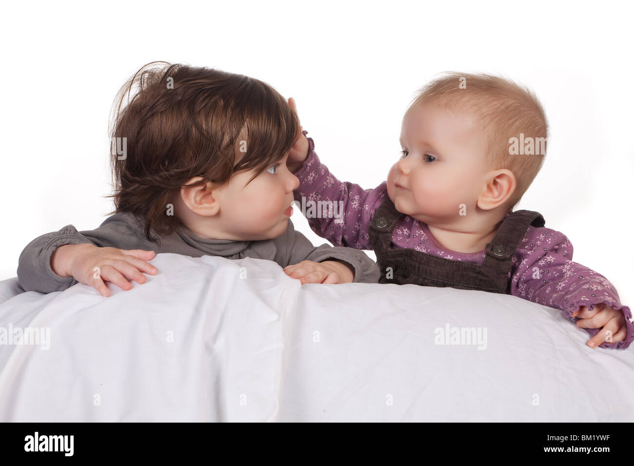 Two four month old shy babies meeting for the first time Stock Photo ...