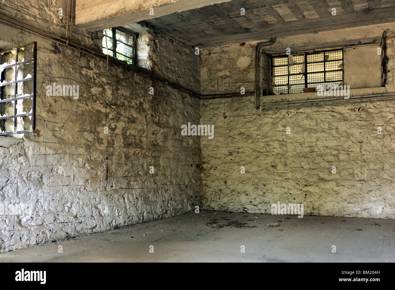 Empty room broken windows and textured white wall. Abandoned factory ...