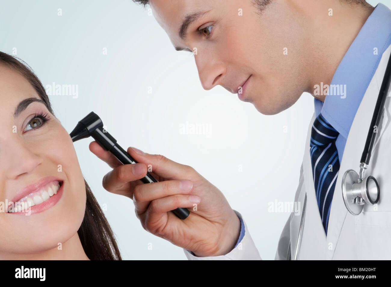 Doctor checking ear hi-res stock photography and images - Alamy