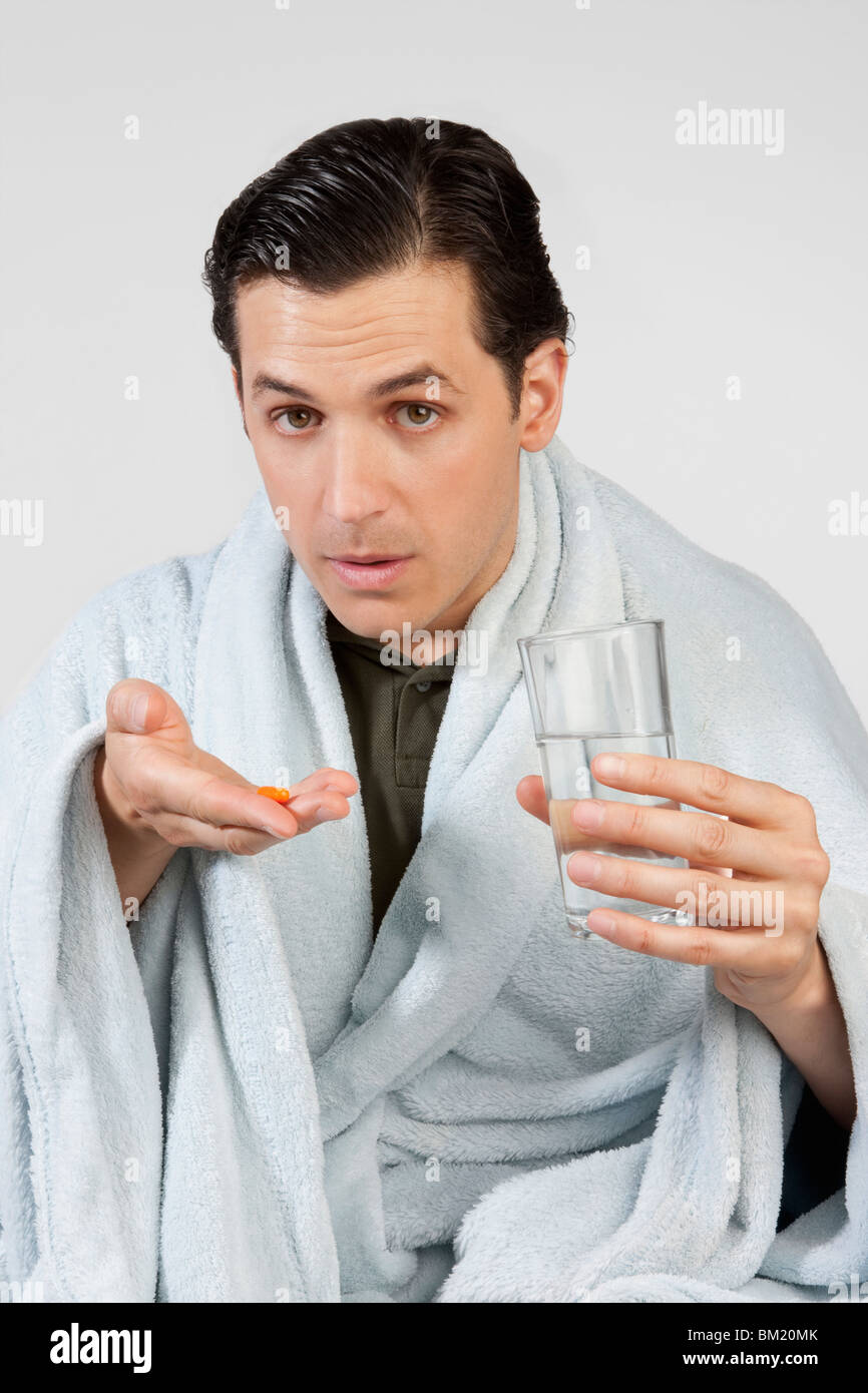 Portrait of a man taking medicine Stock Photo - Alamy