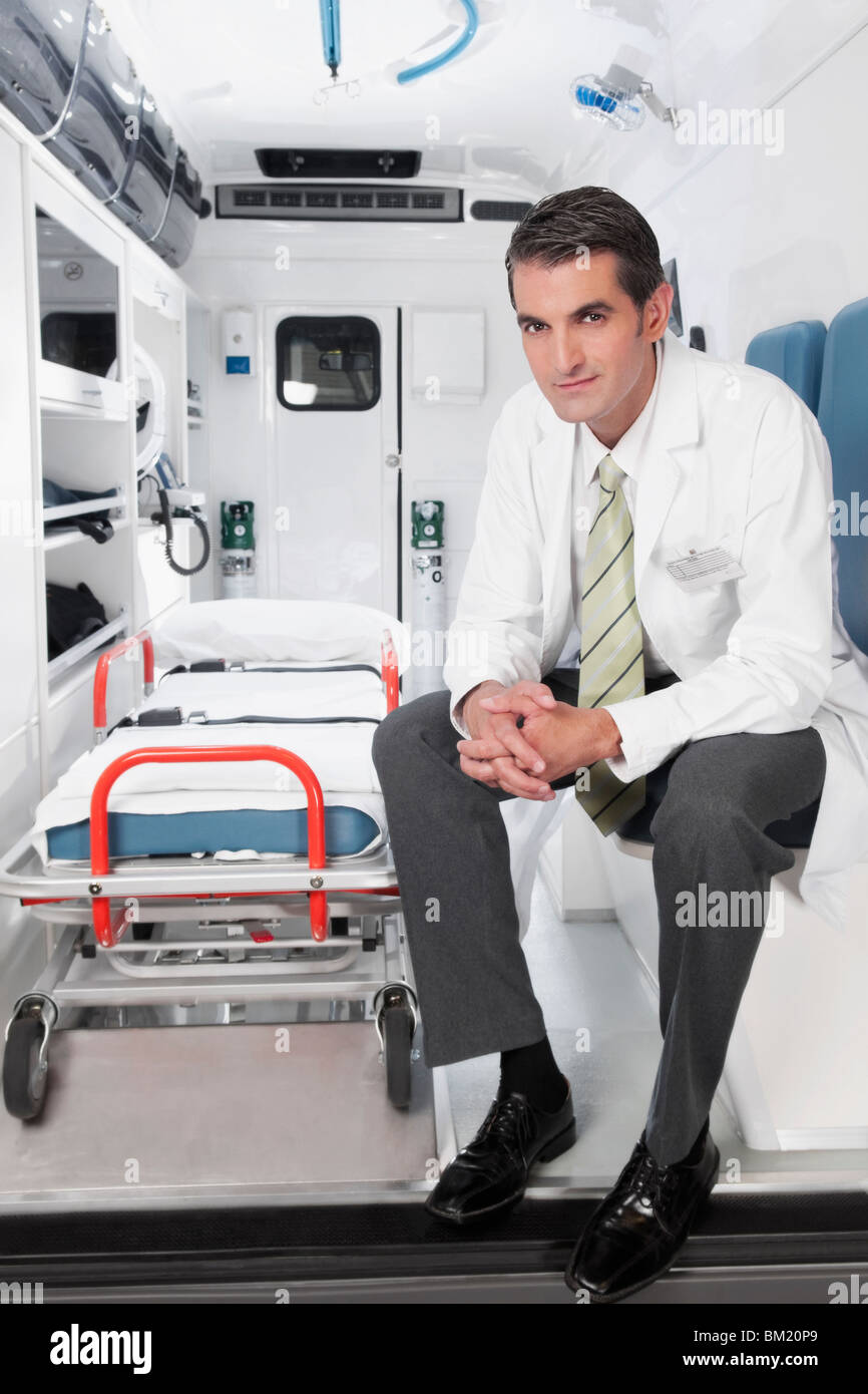 Doctor sitting in an ambulance Stock Photo - Alamy