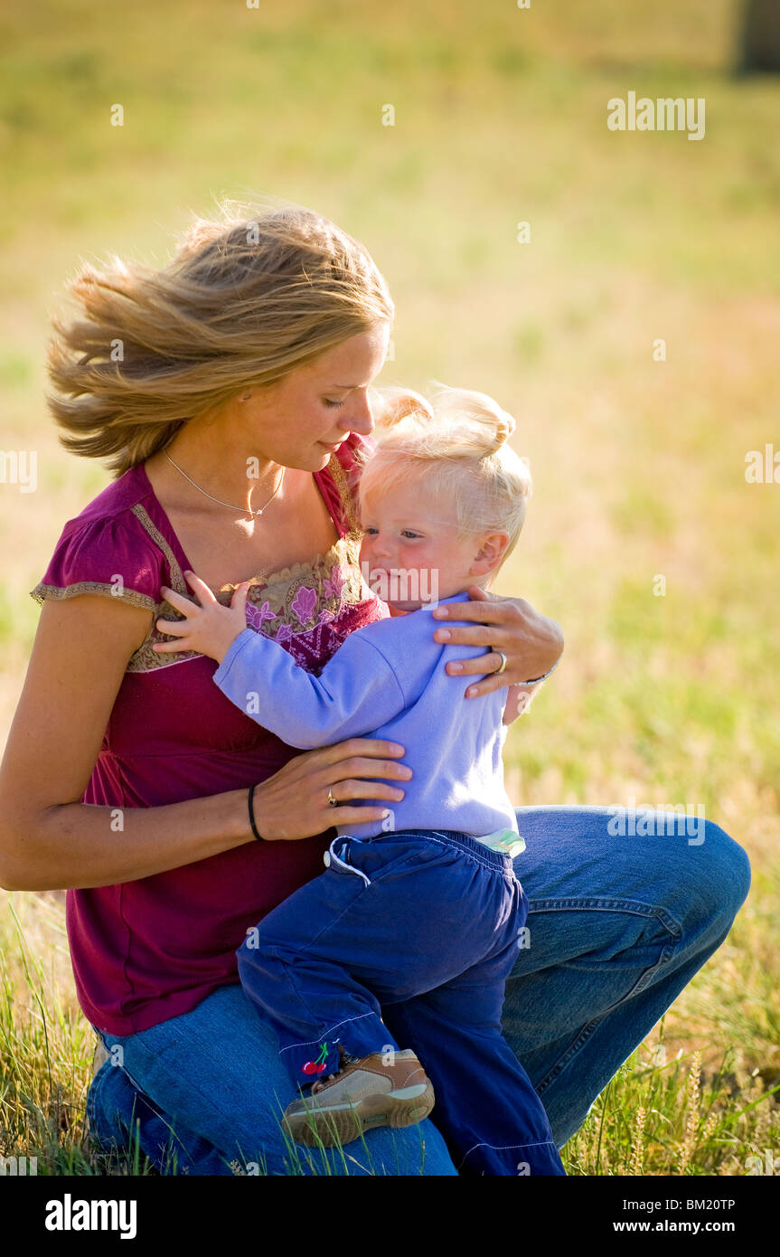 Crouching mother hugging her child hi-res stock photography and images ...