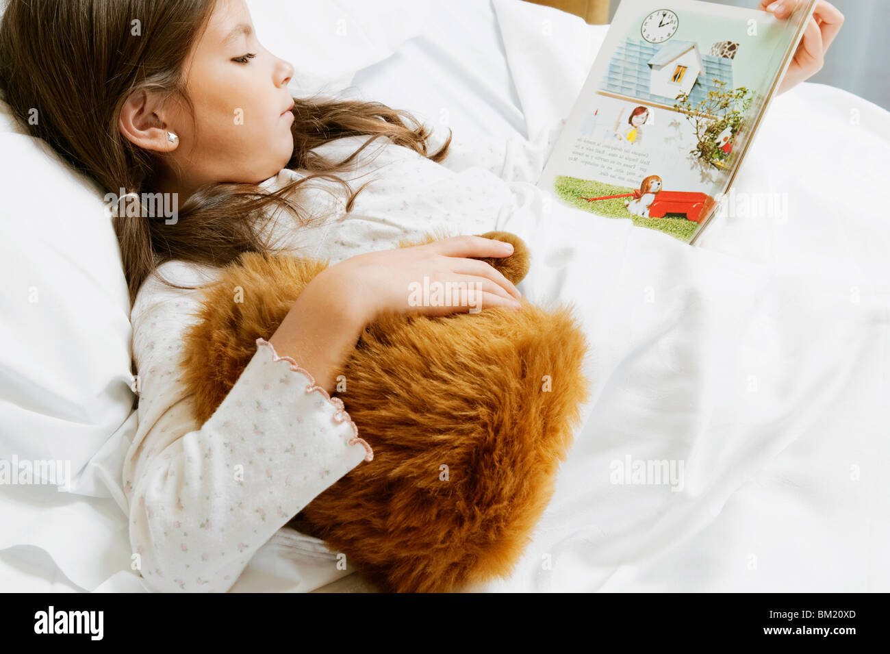 Girl reading a comic book on a hospital bed Stock Photo - Alamy