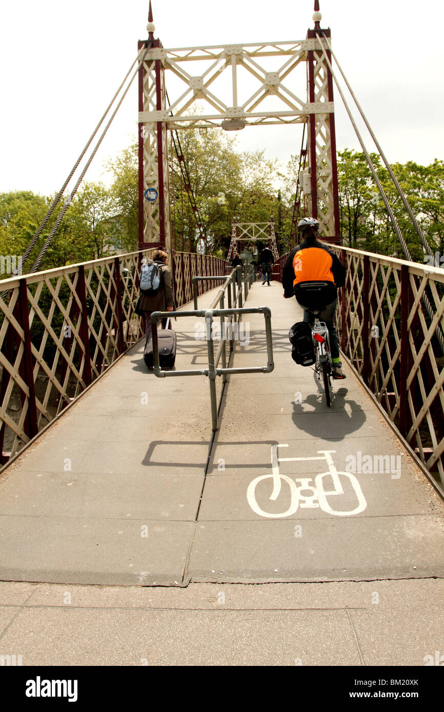 Cycling over a bridge in Bristol Stock Photo - Alamy