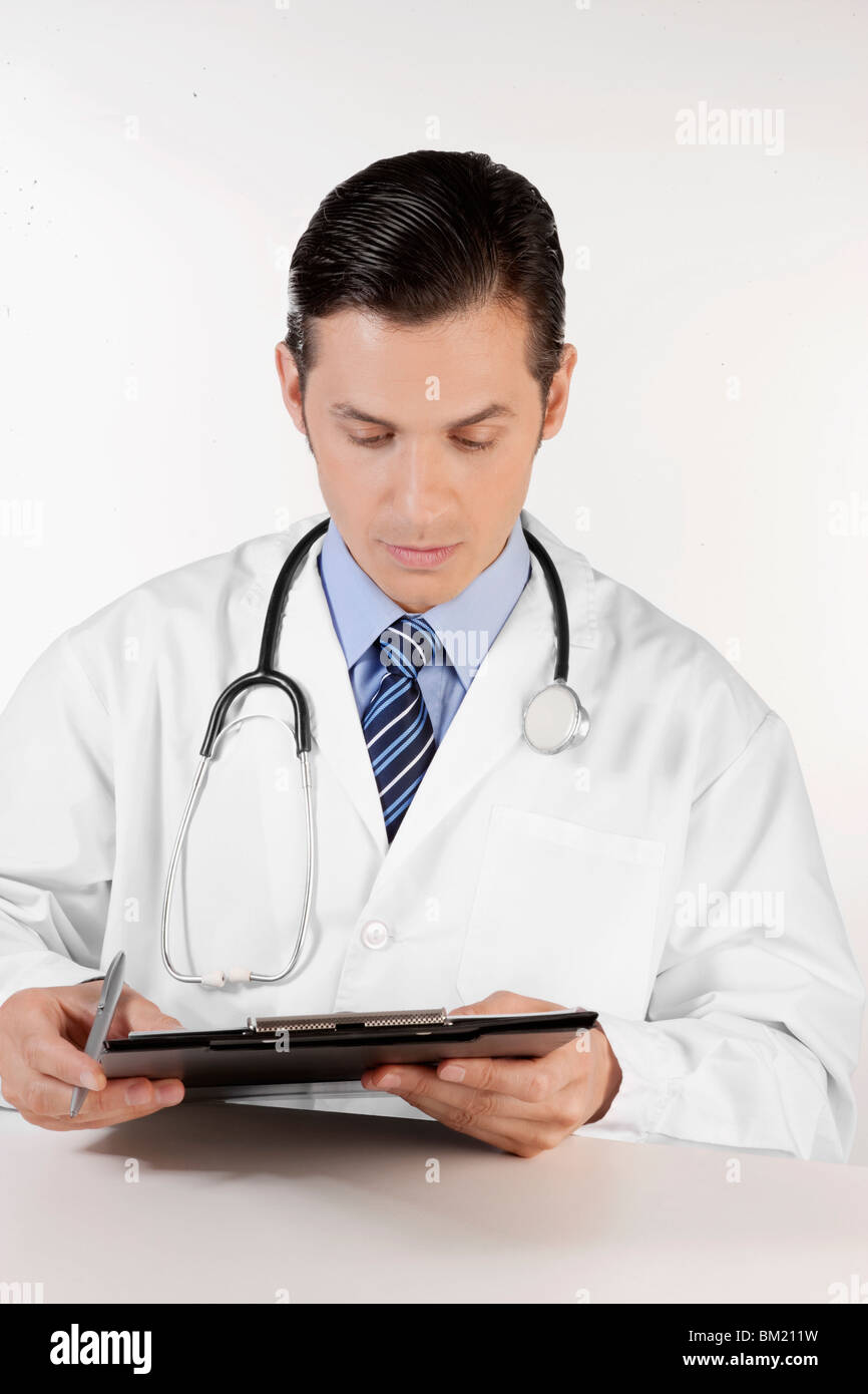 Doctor reading a report Stock Photo - Alamy