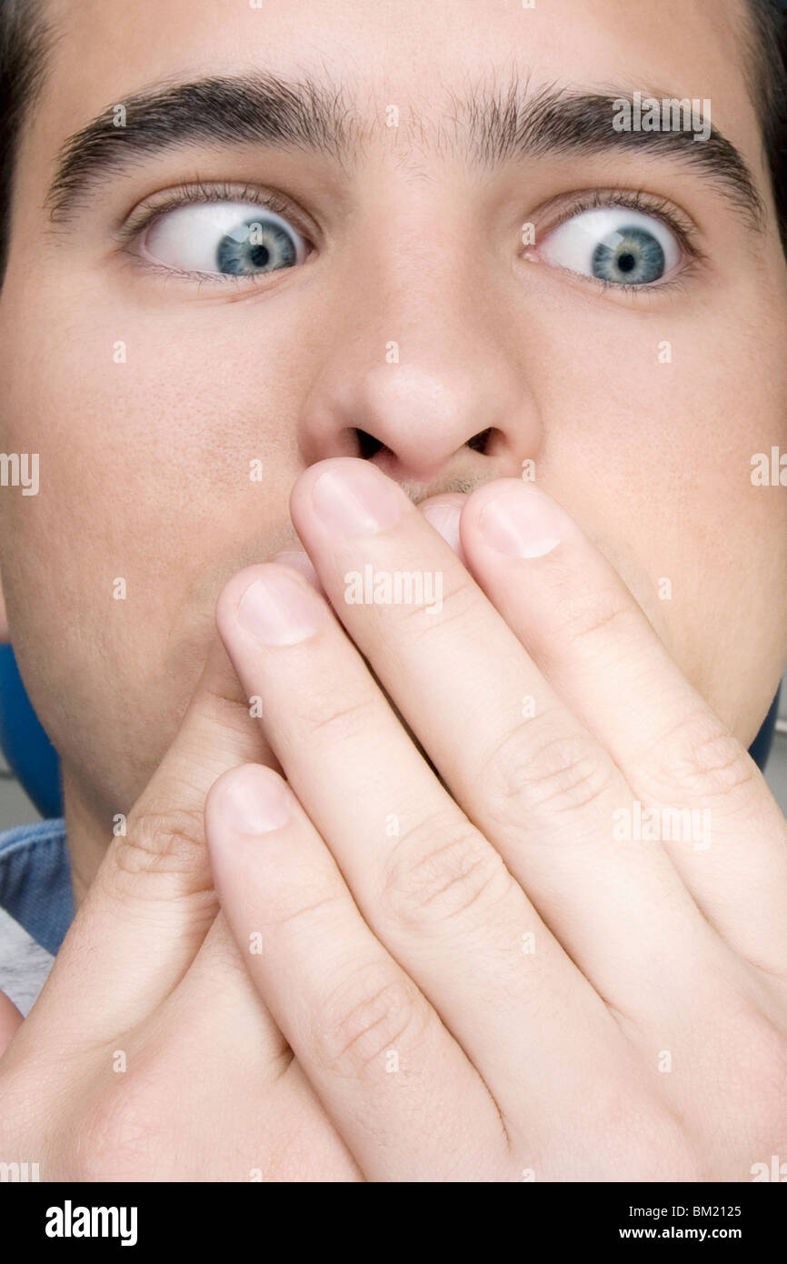 Man covering his mouth Stock Photo - Alamy