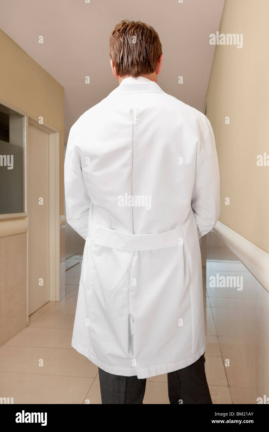 Rear view of a doctor standing at the corridor Stock Photo - Alamy