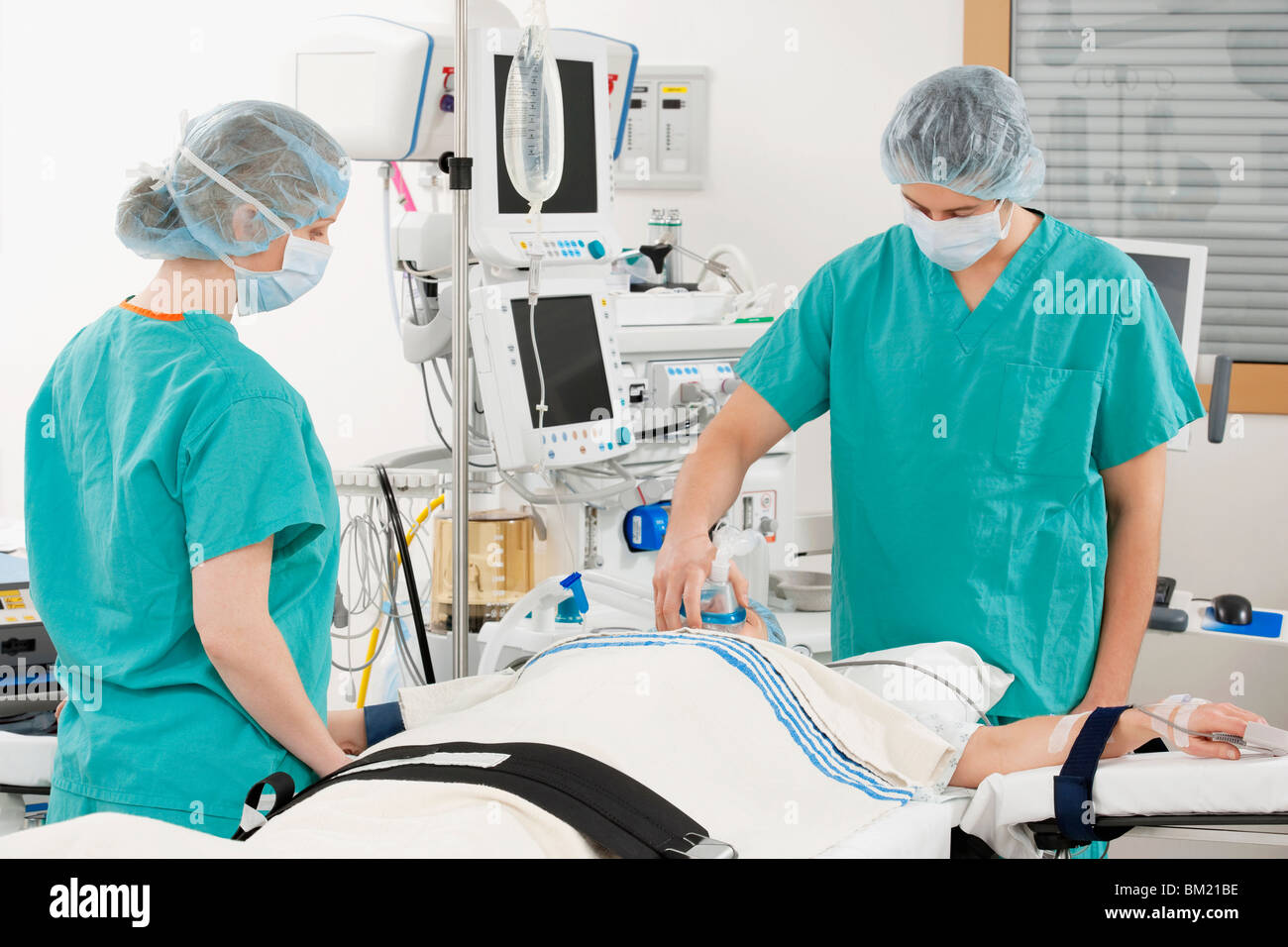 Anesthetist using an oxygen mask on a patient in a hospital Stock Photo ...
