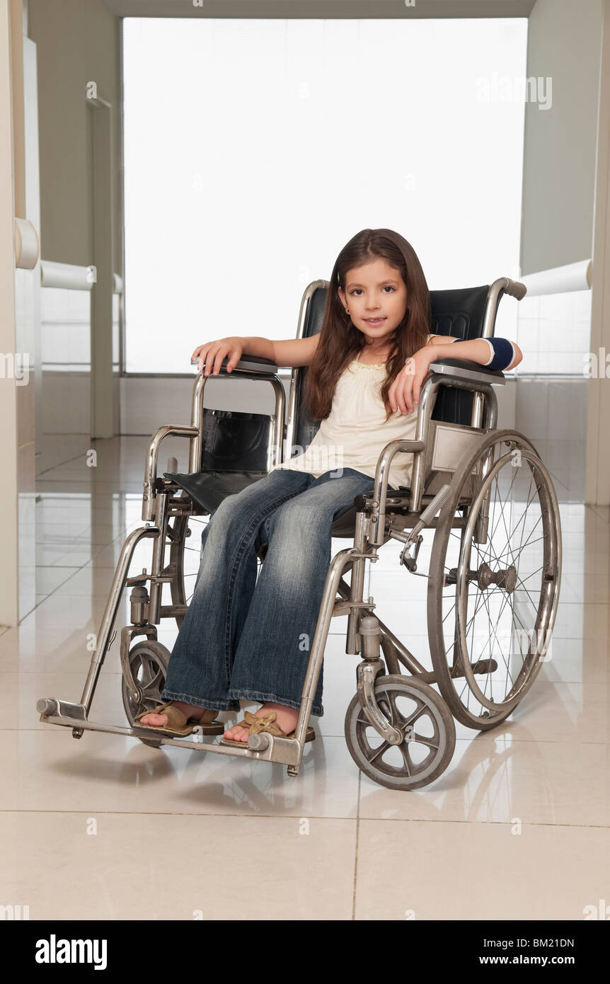 Girl sitting in a wheelchair Stock Photo - Alamy