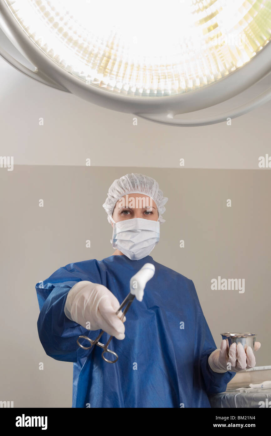 Surgeon holding surgical scissors in an operating room Stock Photo - Alamy