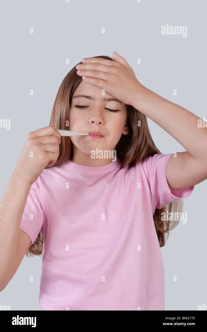 Girl taking her temperature Stock Photo - Alamy