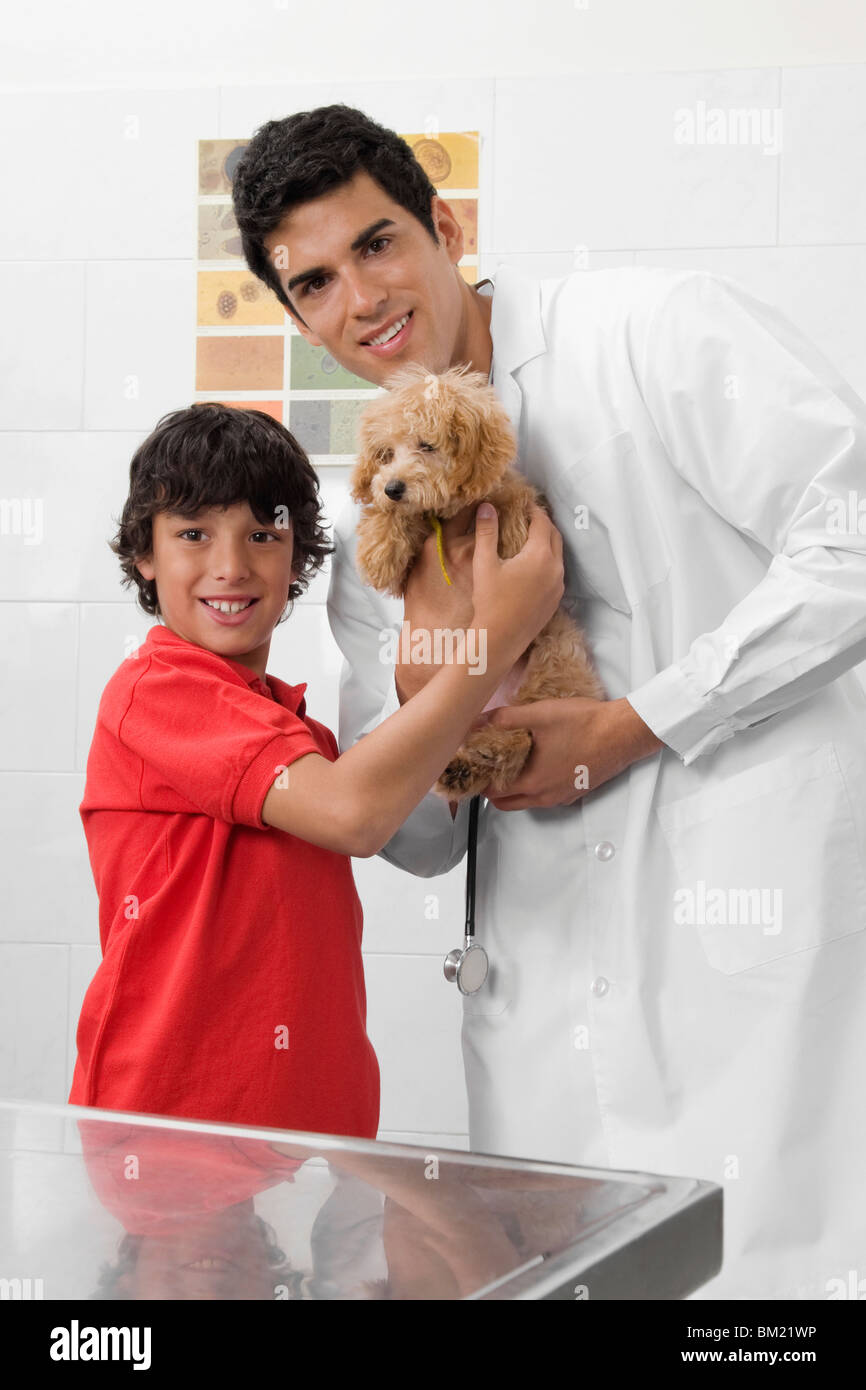 Vet and a boy carrying a dog Stock Photo - Alamy