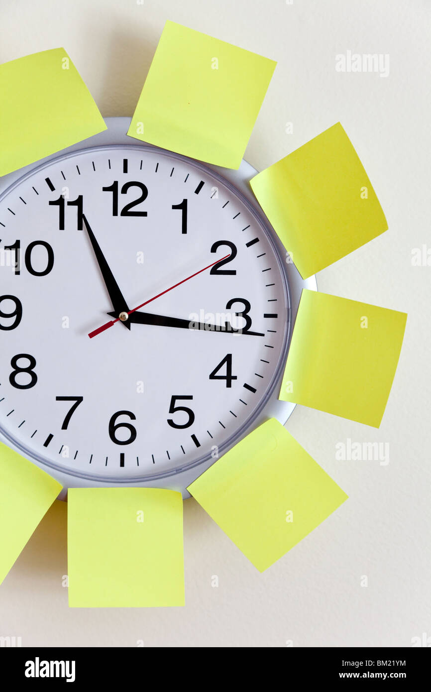Clock and Adhesive Note close up Stock Photo - Alamy