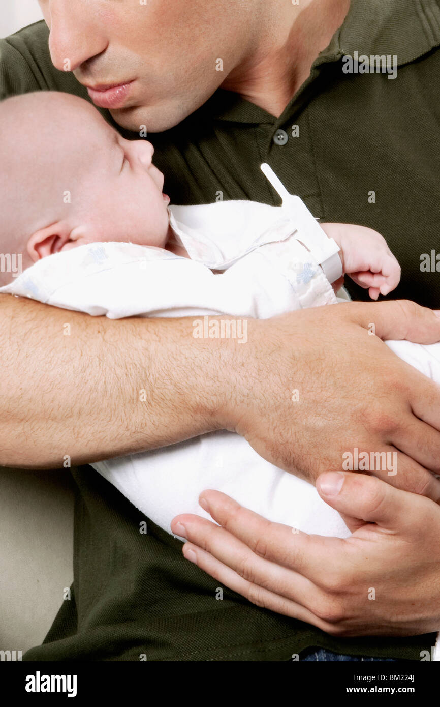 Man pampering his newborn baby Stock Photo - Alamy