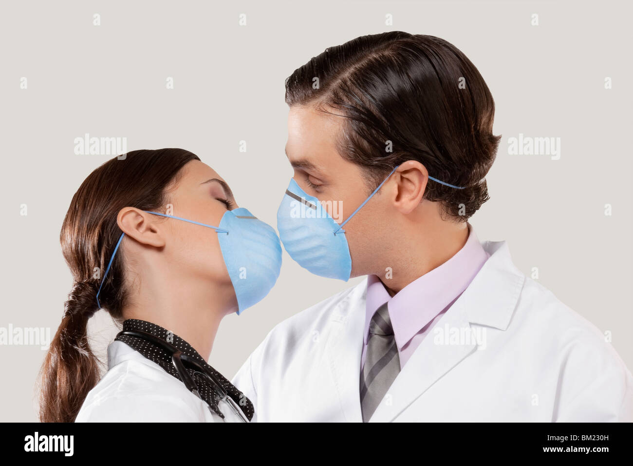 Doctors wearing flu masks and romancing Stock Photo - Alamy