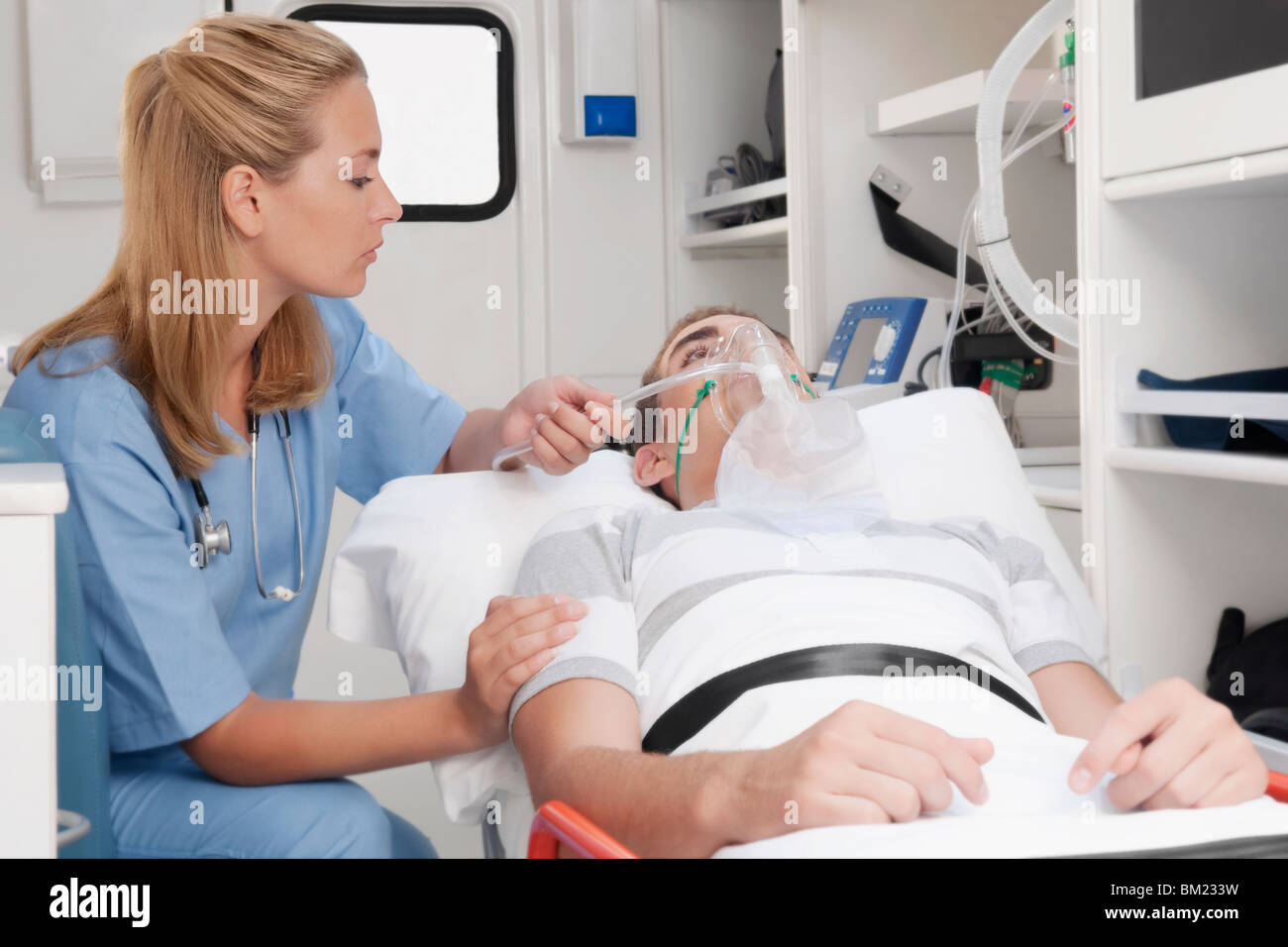 Female nurse assisting a patient in an ambulance Stock Photo - Alamy