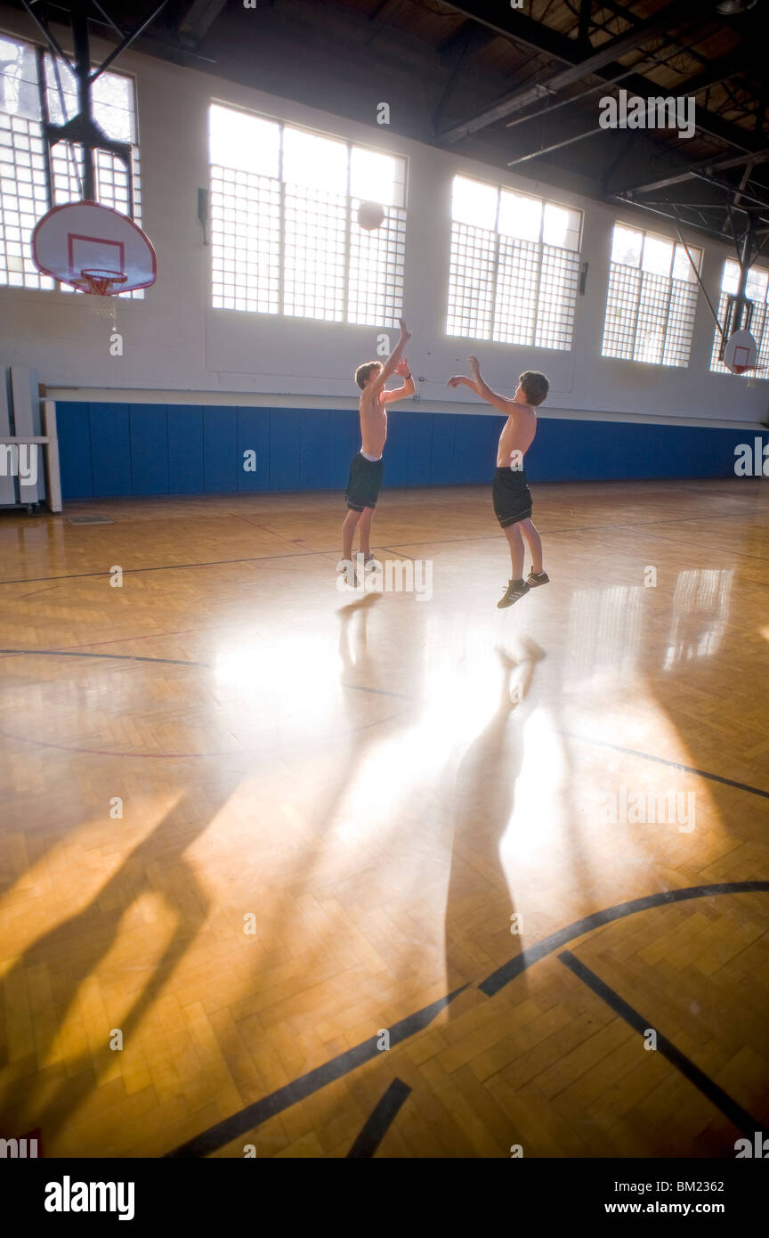 Two boys practicing basketball in a high school gymnasium, Bozeman ...