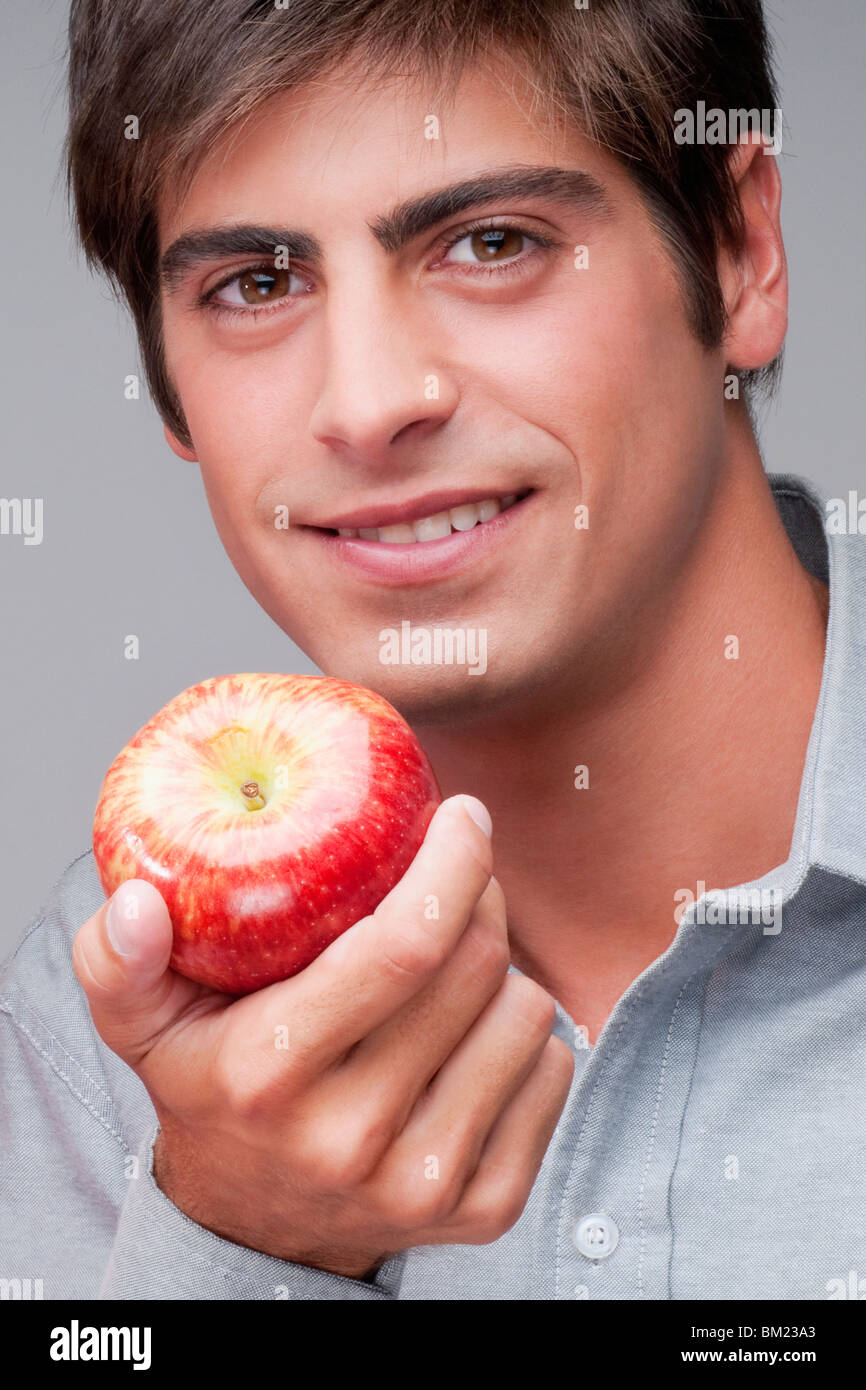 Portrait of a man eating an apple Stock Photo - Alamy