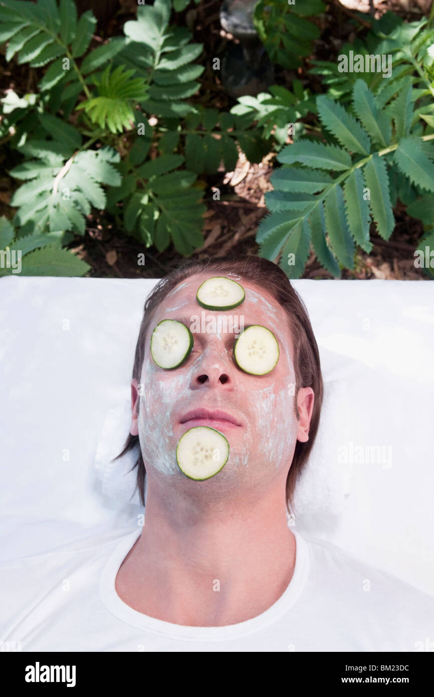 Cucumber slices on a man's face Stock Photo - Alamy