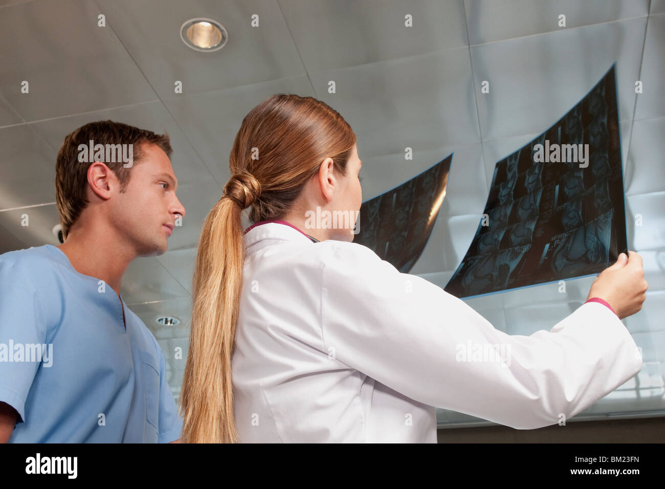 Doctor and a male nurse examining an MRI scan report Stock Photo - Alamy