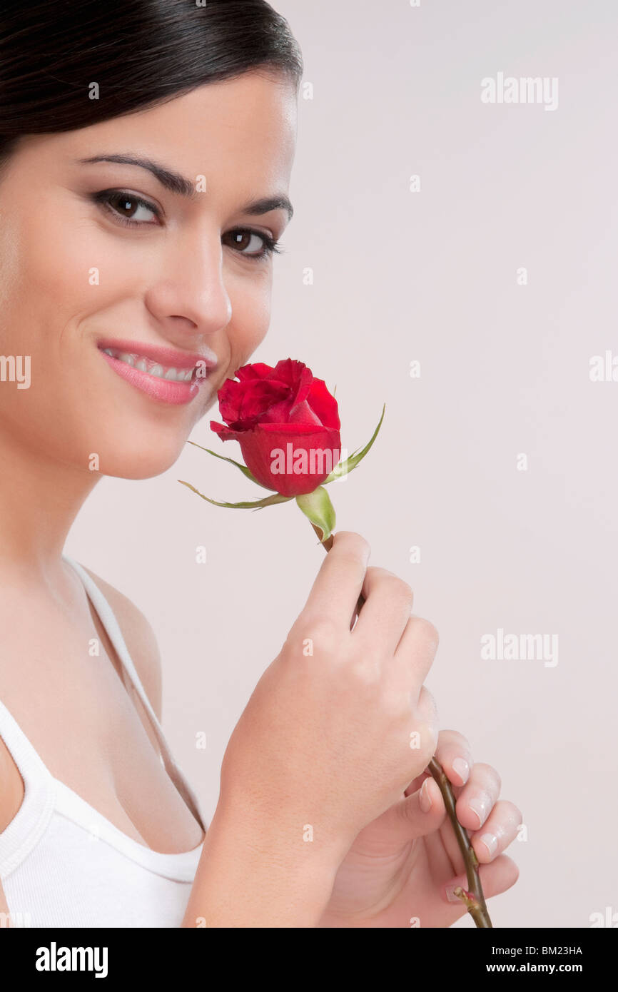 Woman with red hair smelling a red rose hi-res stock photography and ...