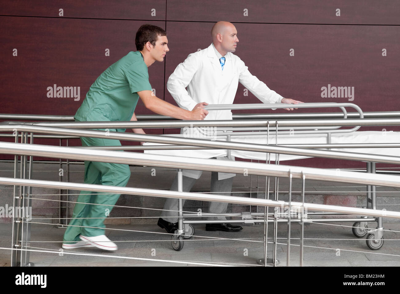 Doctor male nurse pushing hospital hi-res stock photography and images ...