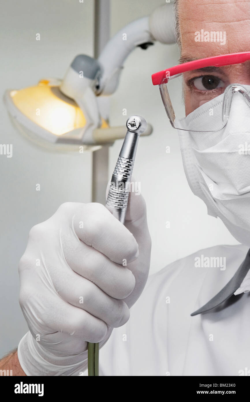 Dentist holding a dental drill Stock Photo - Alamy