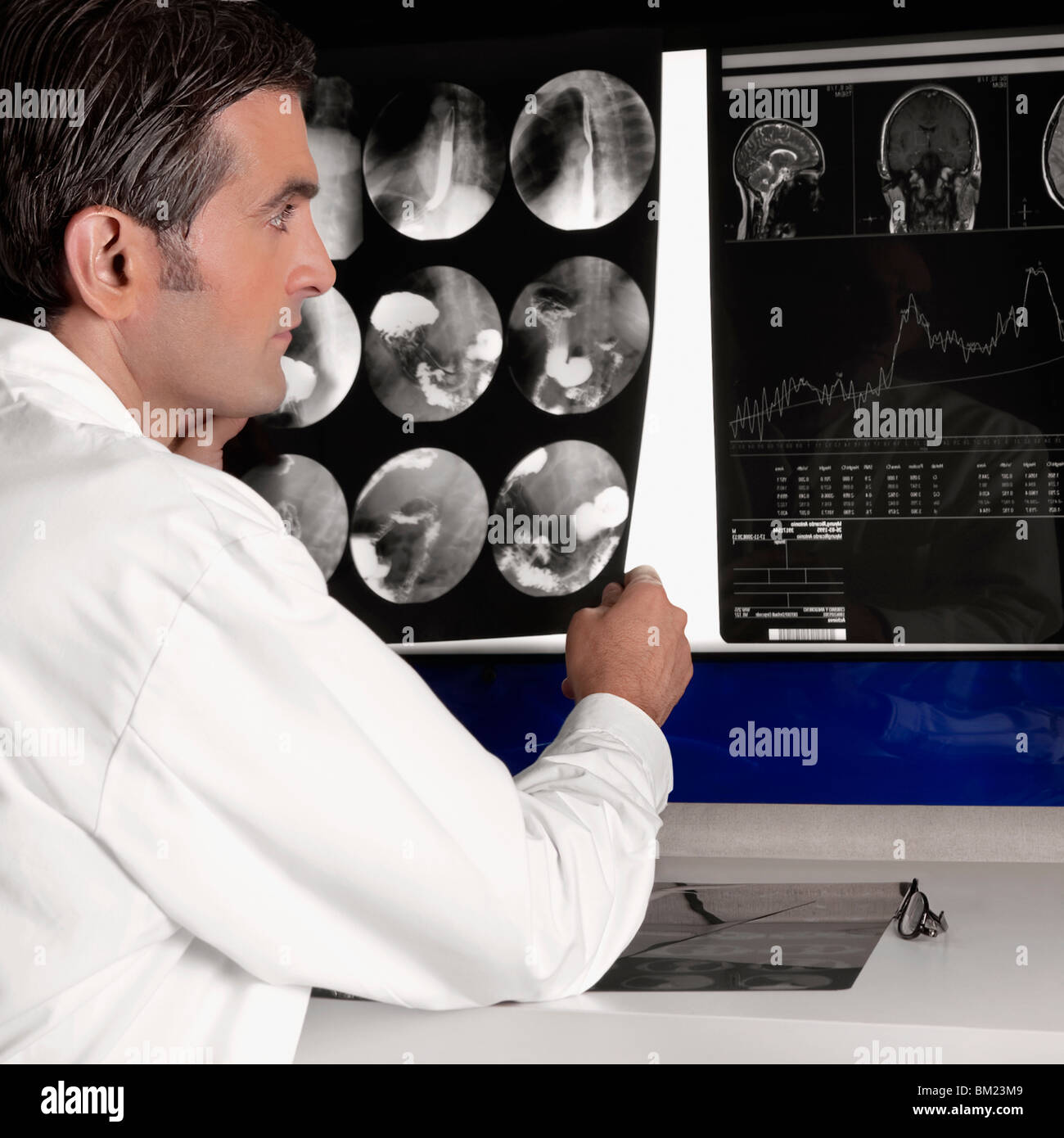 Doctor examining MRI report Stock Photo - Alamy