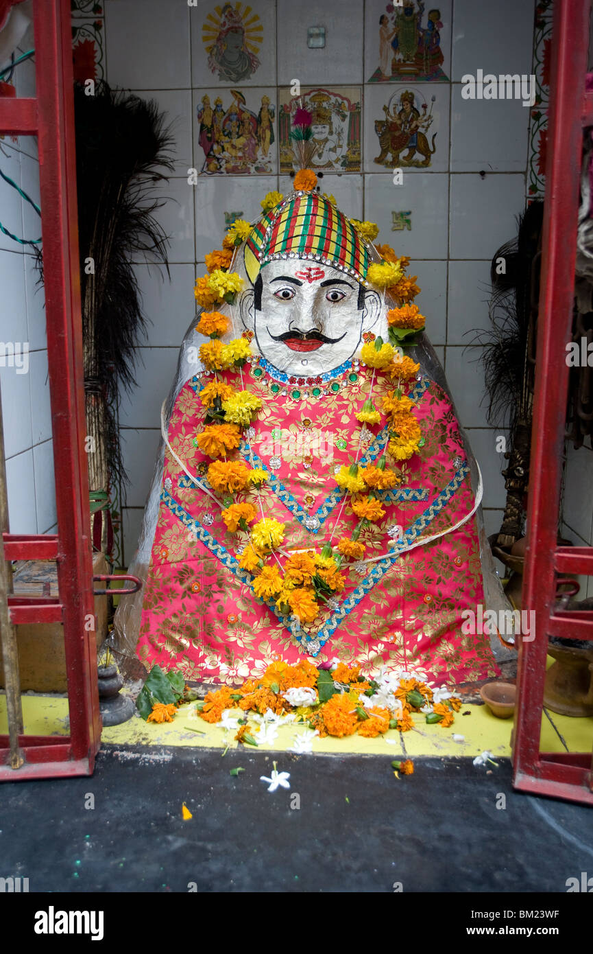 Hindu street shrine, decorated with marigold mala (garlands) for Diwali ...