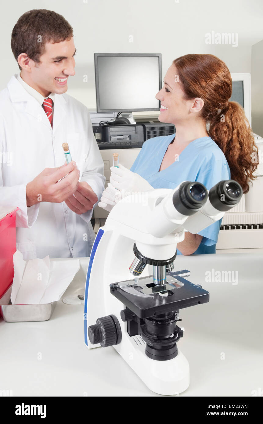 Lab technicians analyzing sample in test tubes Stock Photo - Alamy