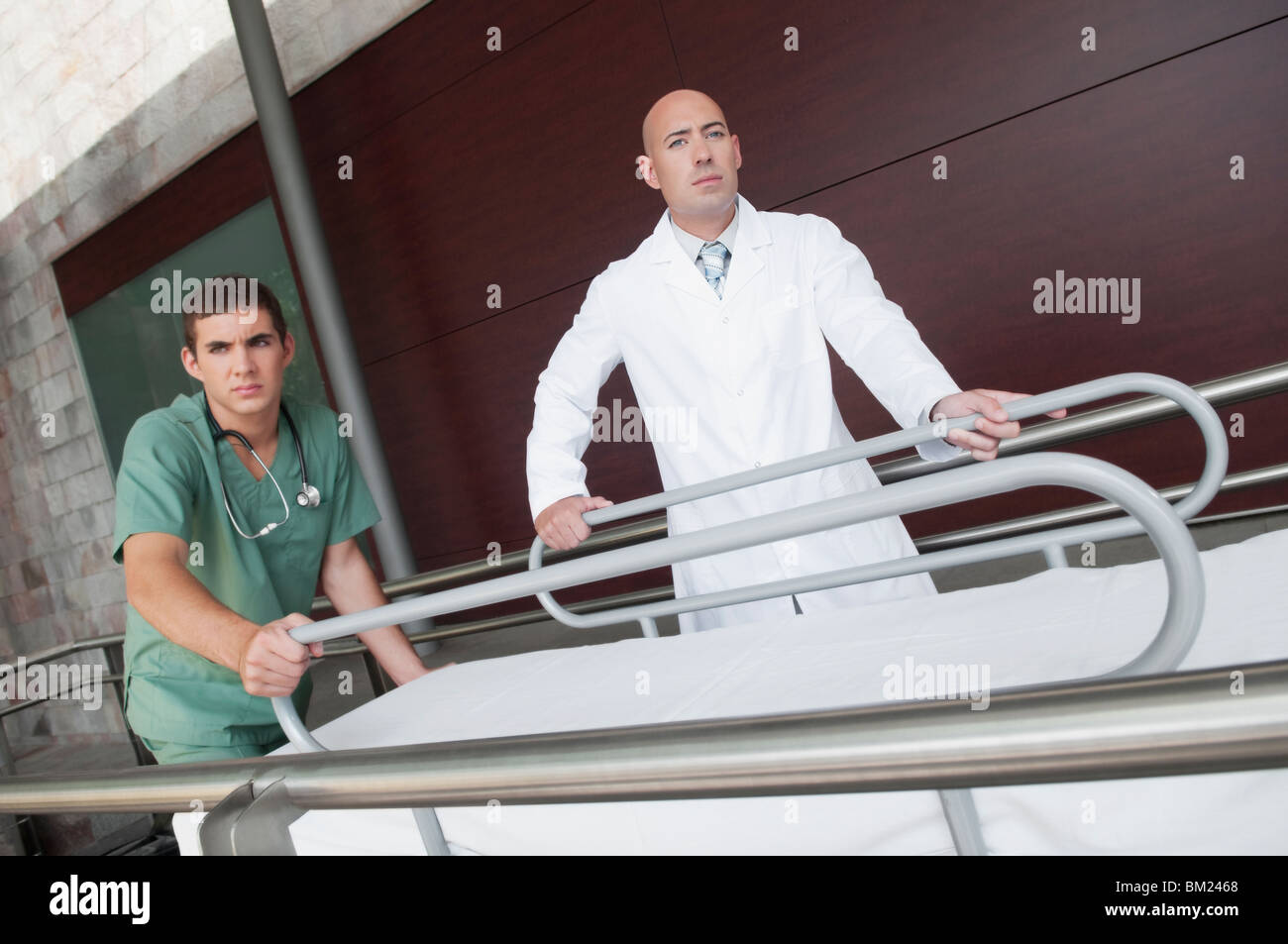 Doctor male nurse pushing hospital hi-res stock photography and images ...