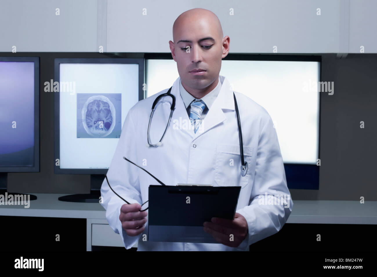 Doctor examining a medical report Stock Photo - Alamy