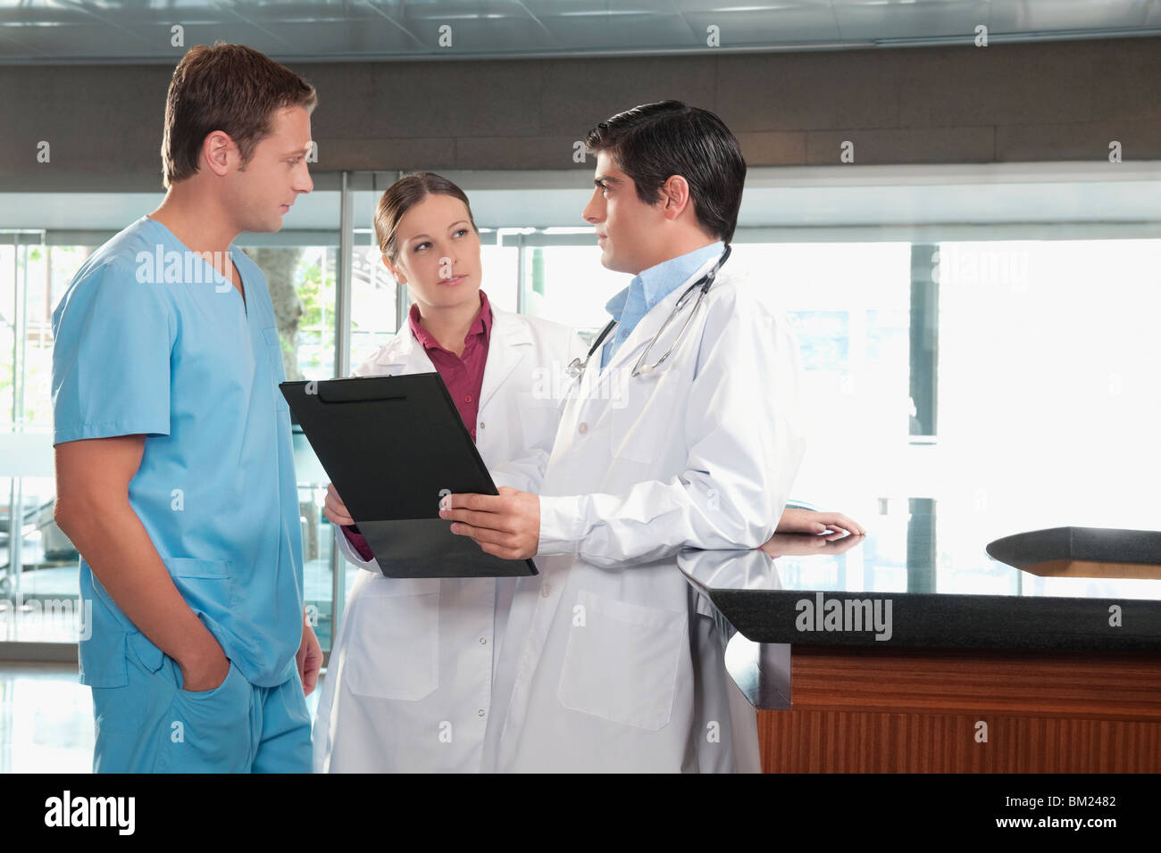 Three doctors discussing a medical report Stock Photo - Alamy Three doctors discussing a medical report Stock Photo - Alamy