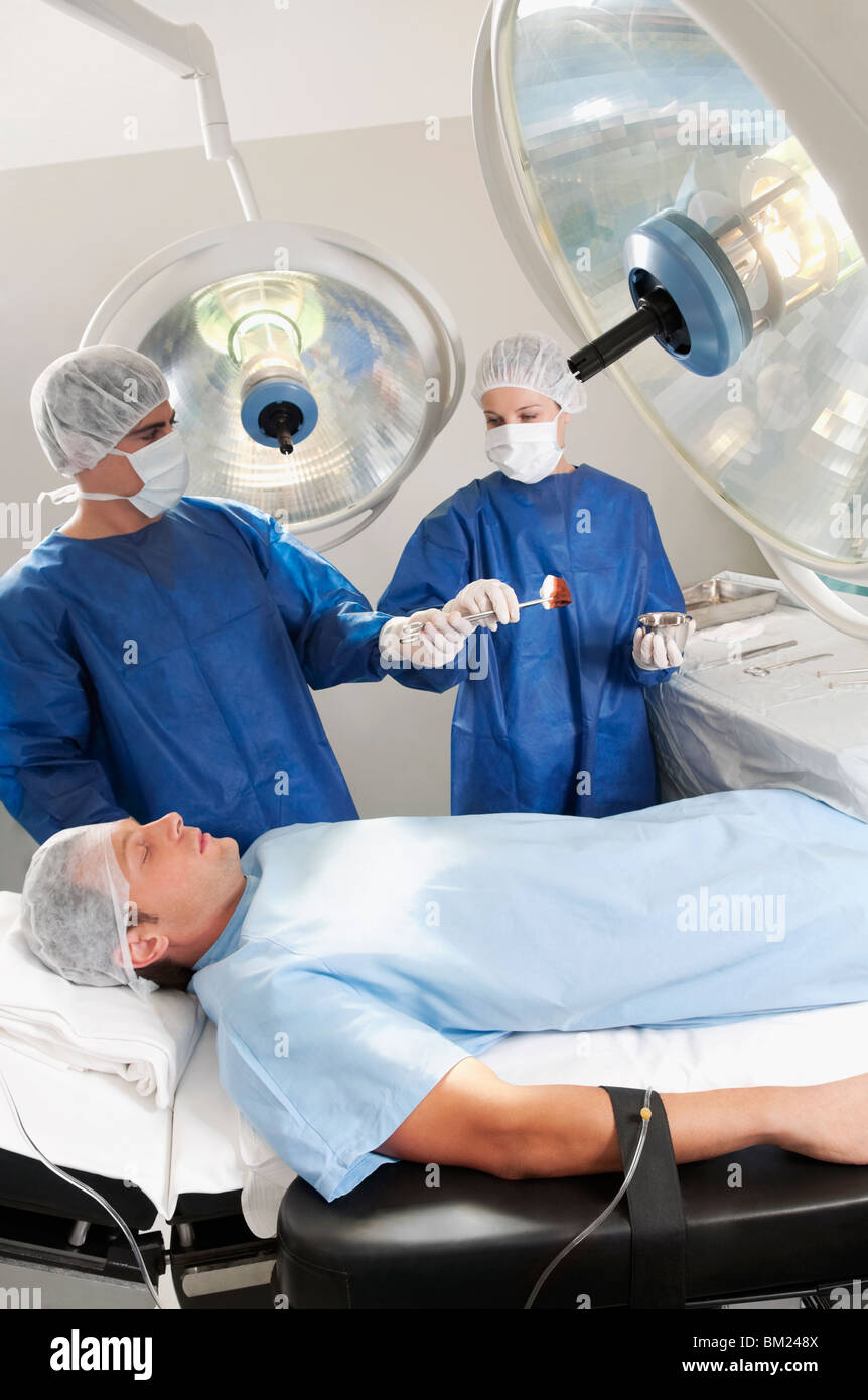 Two surgeons operating a patient in an operating room Stock Photo - Alamy