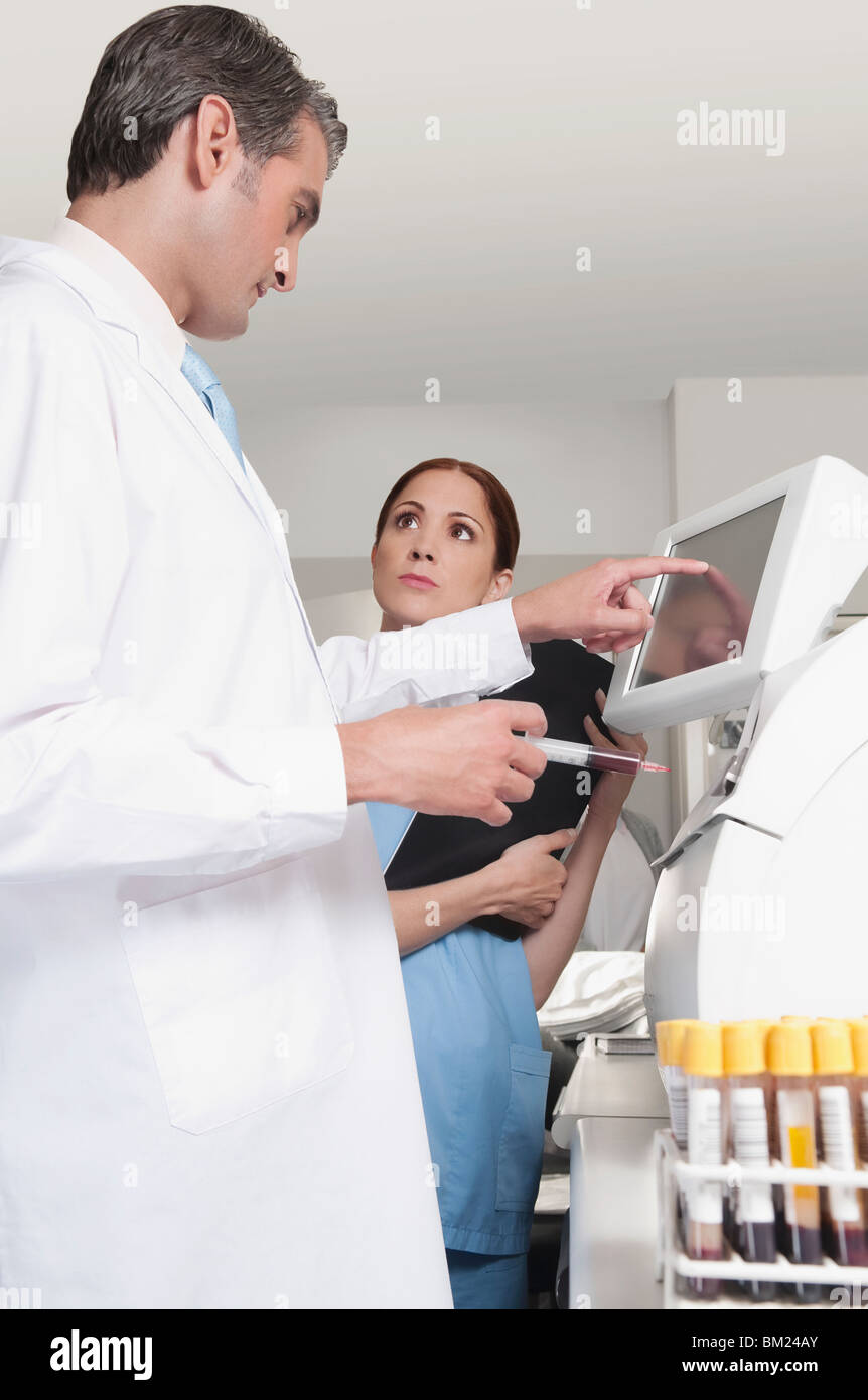 Lab technician testing blood samples in a laboratory Stock Photo - Alamy