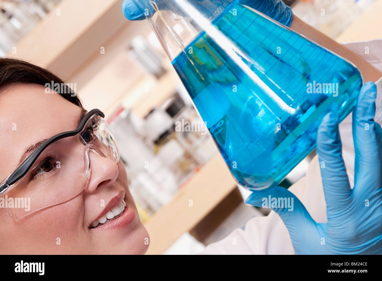 Female doctor holding a conical flask in a laboratory Stock Photo - Alamy